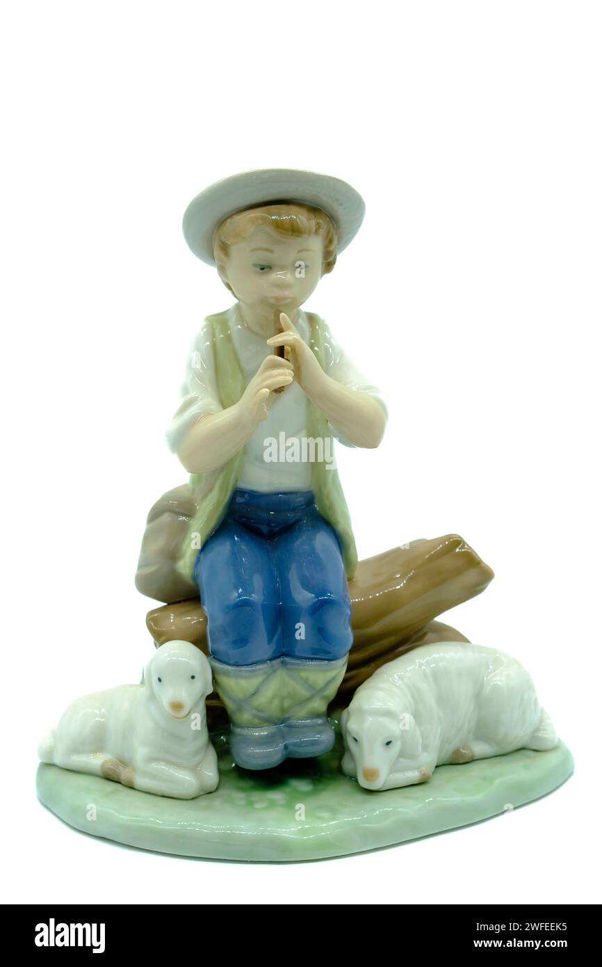 Antique porcelain figure of a boy shepherd playing the whistle or pipes ...