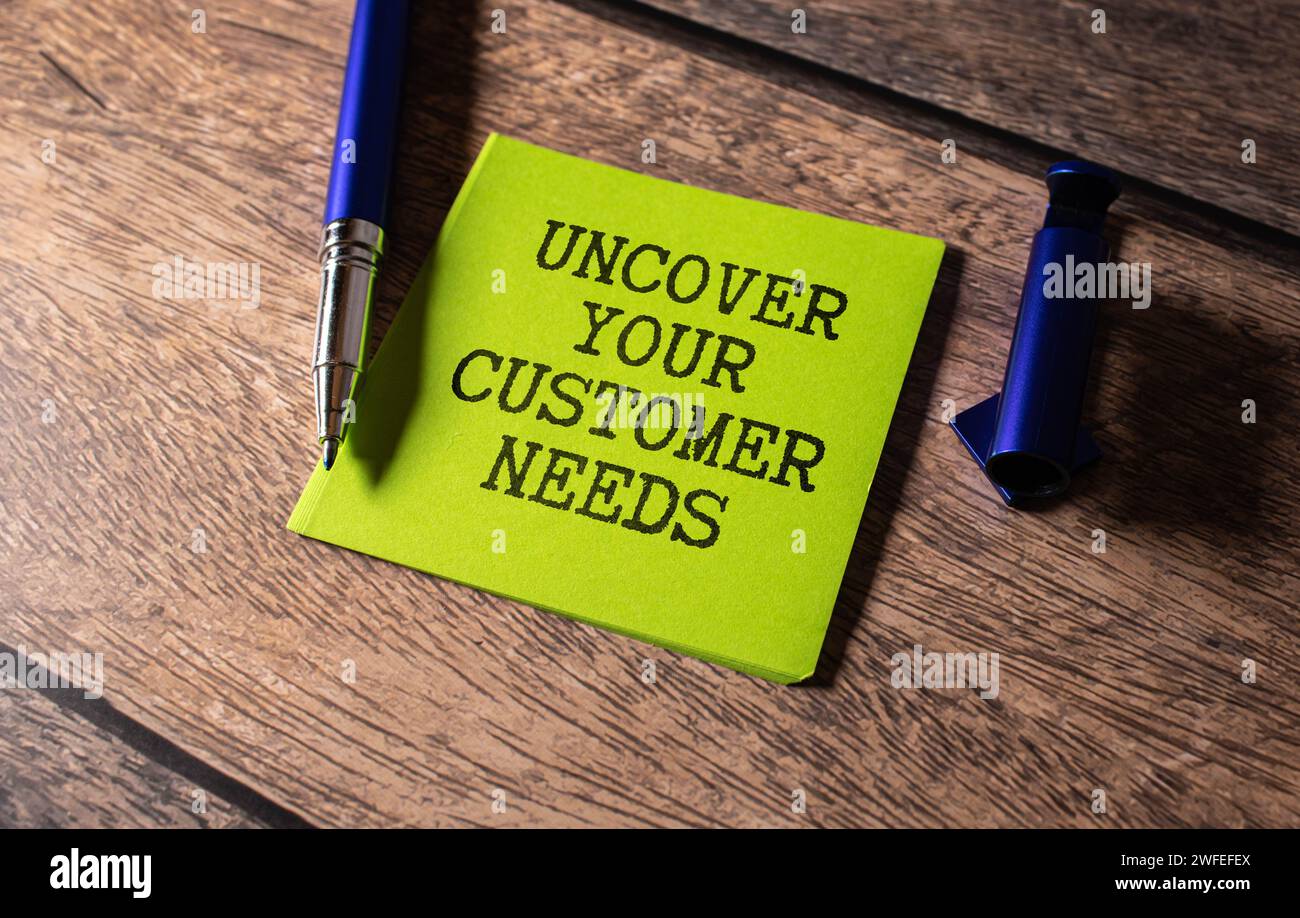 Uncover your customer needs text on white notepad, Business concept ...