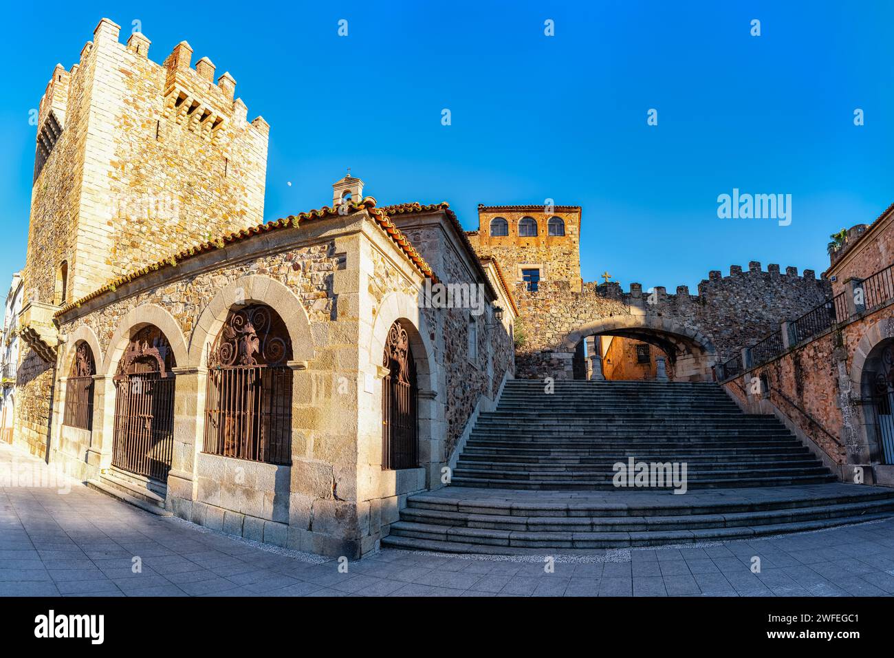 A group of medieval buildings next to the main square of Caceres, a ...