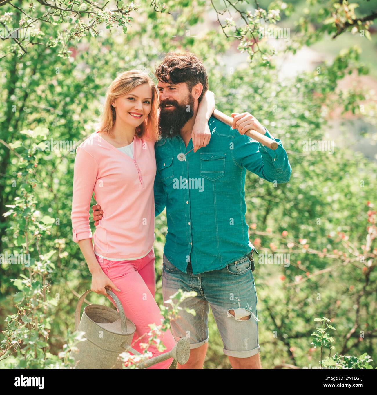 Portrait of pair of farms Working In Garden Together. Cheerful couple ...
