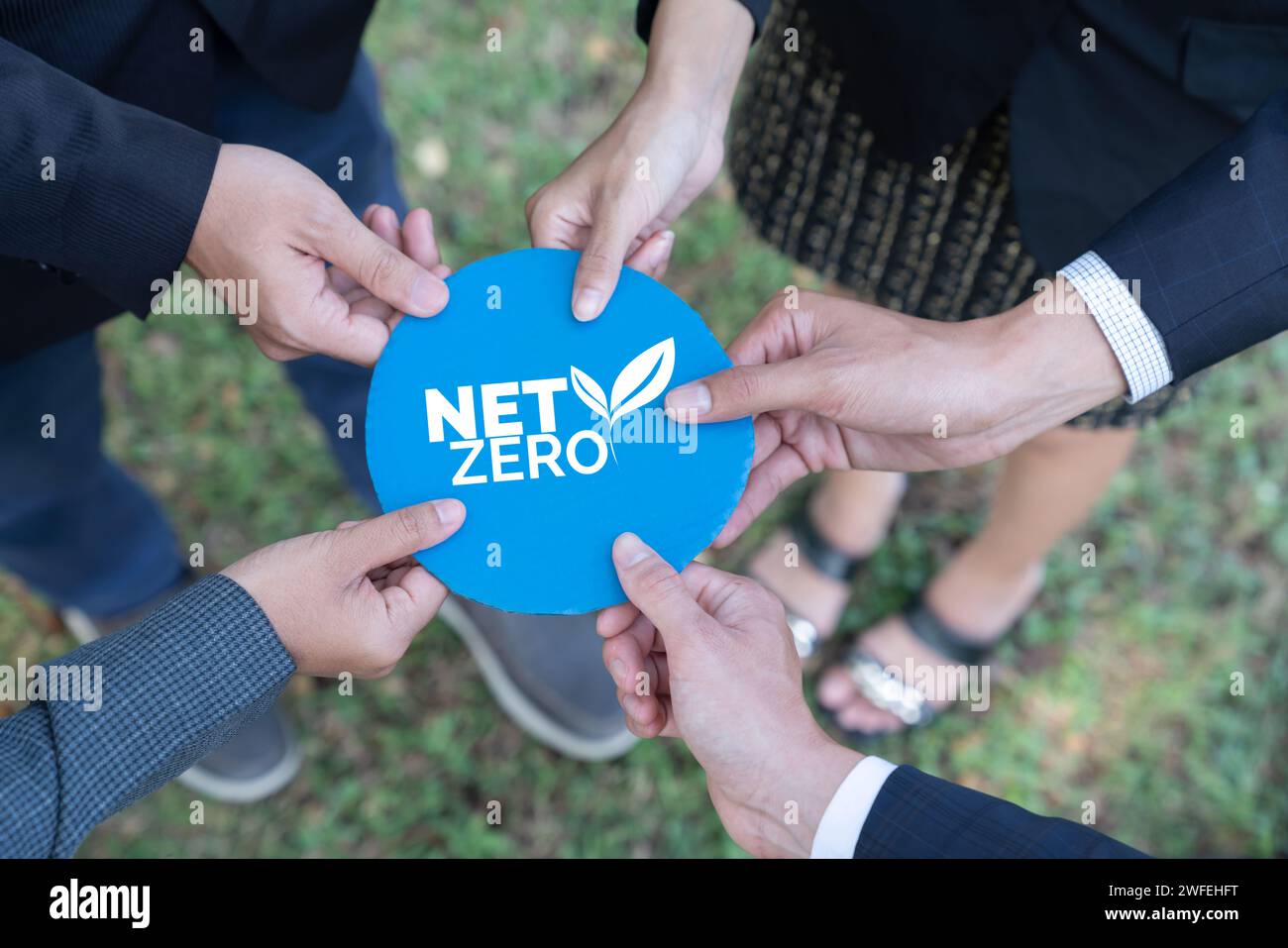 Business people holding ECO friendly idea symbol together as group of ...