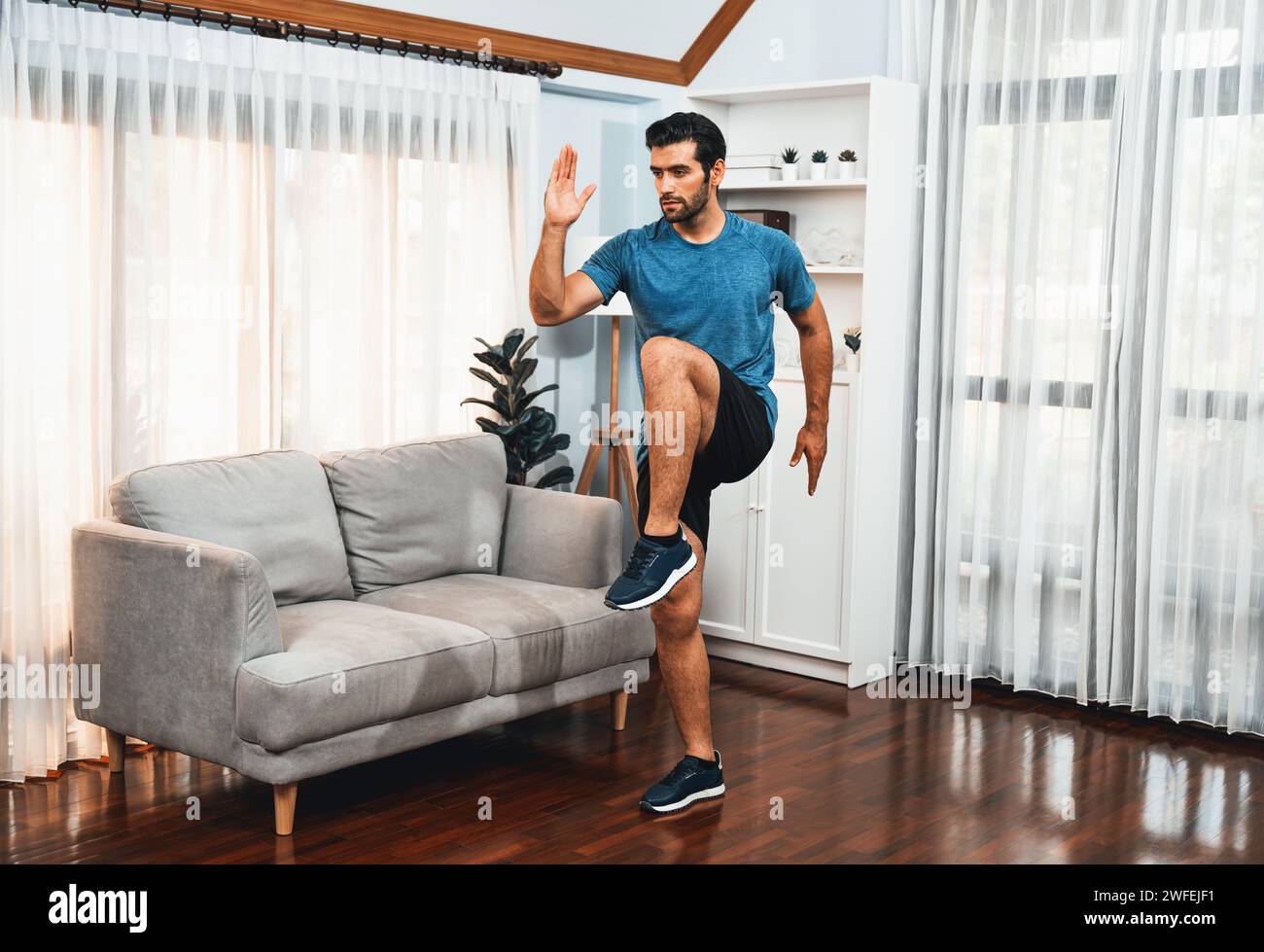 Athletic and sporty man running posture at home body workout exercise ...