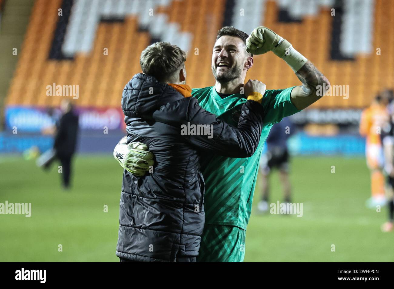 Daniel Grimshaw of Blackpool congratulates fellow goalkeeping team mate ...