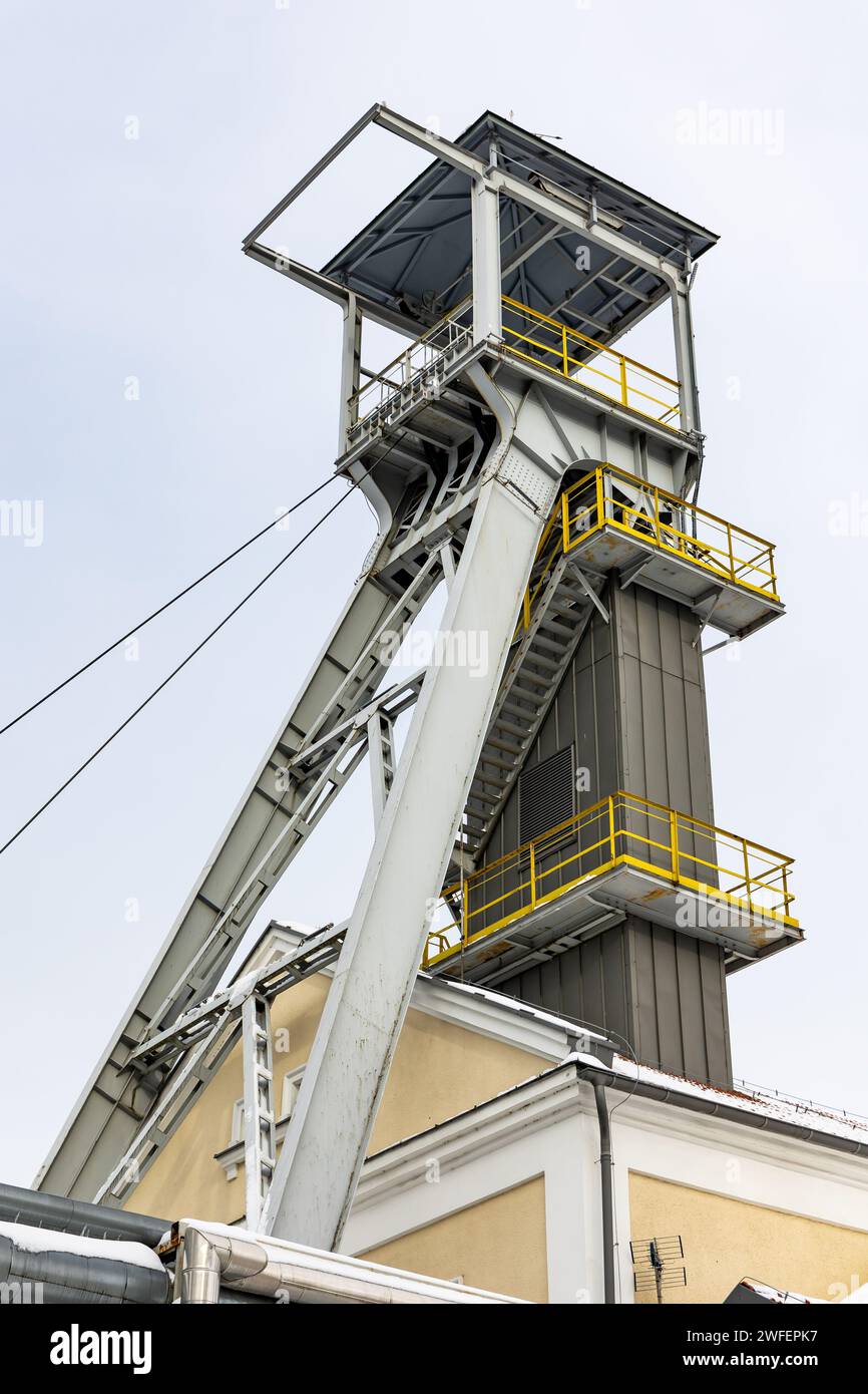 A mine hoist shaft against a gray sky. Close up of the wheels at the ...
