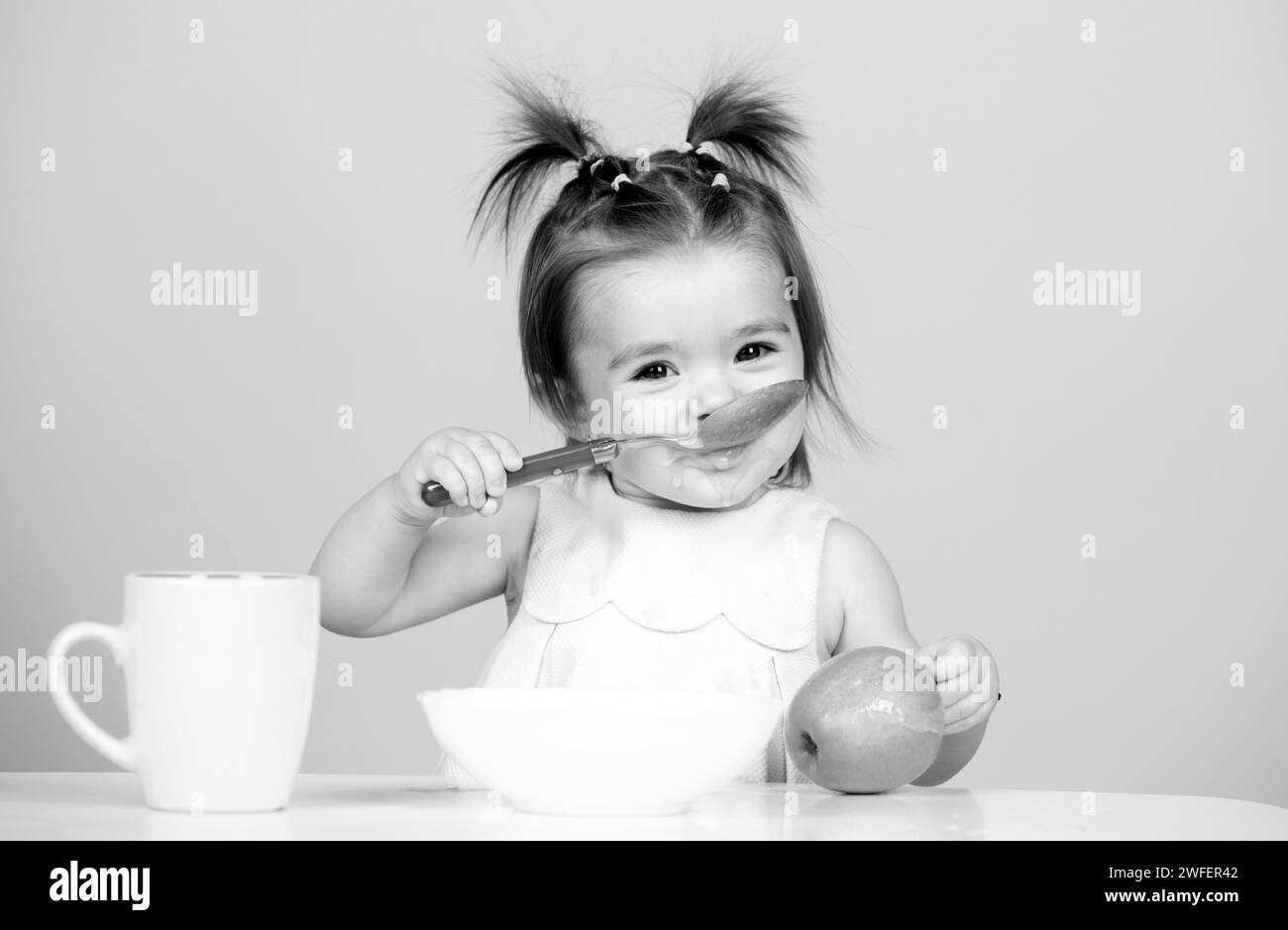 Cute baby child eat food, babies eating. Happy smiling baby with spoon ...