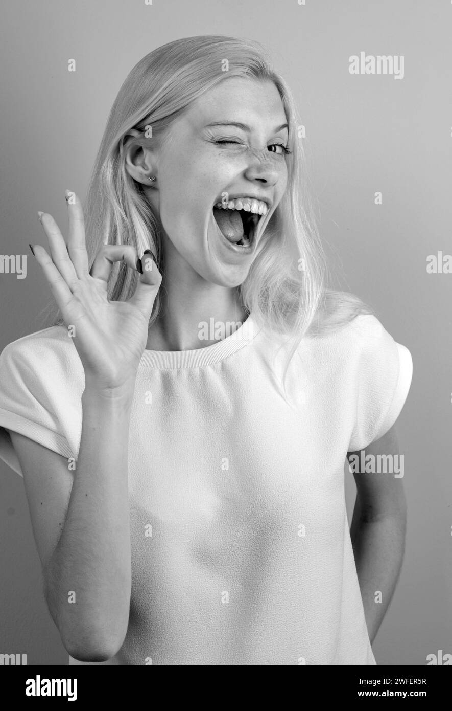 Close up portrait of a pretty young woman winking. Cute funny lady ...