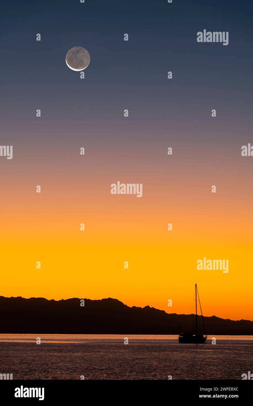 Sailboat under crescent moon, Baja, California Sur, Mexico Stock Photo ...