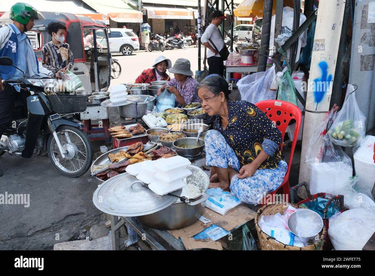 Woman selling food and other cheap items on the street in downtown ...