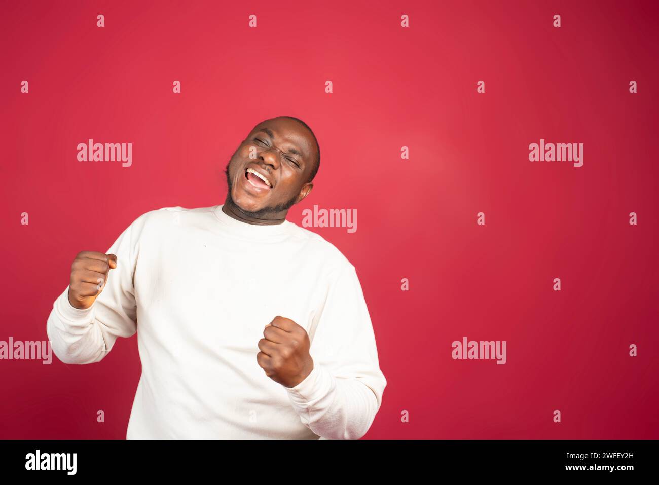 Portrait of excited young African American male screaming in shock and ...