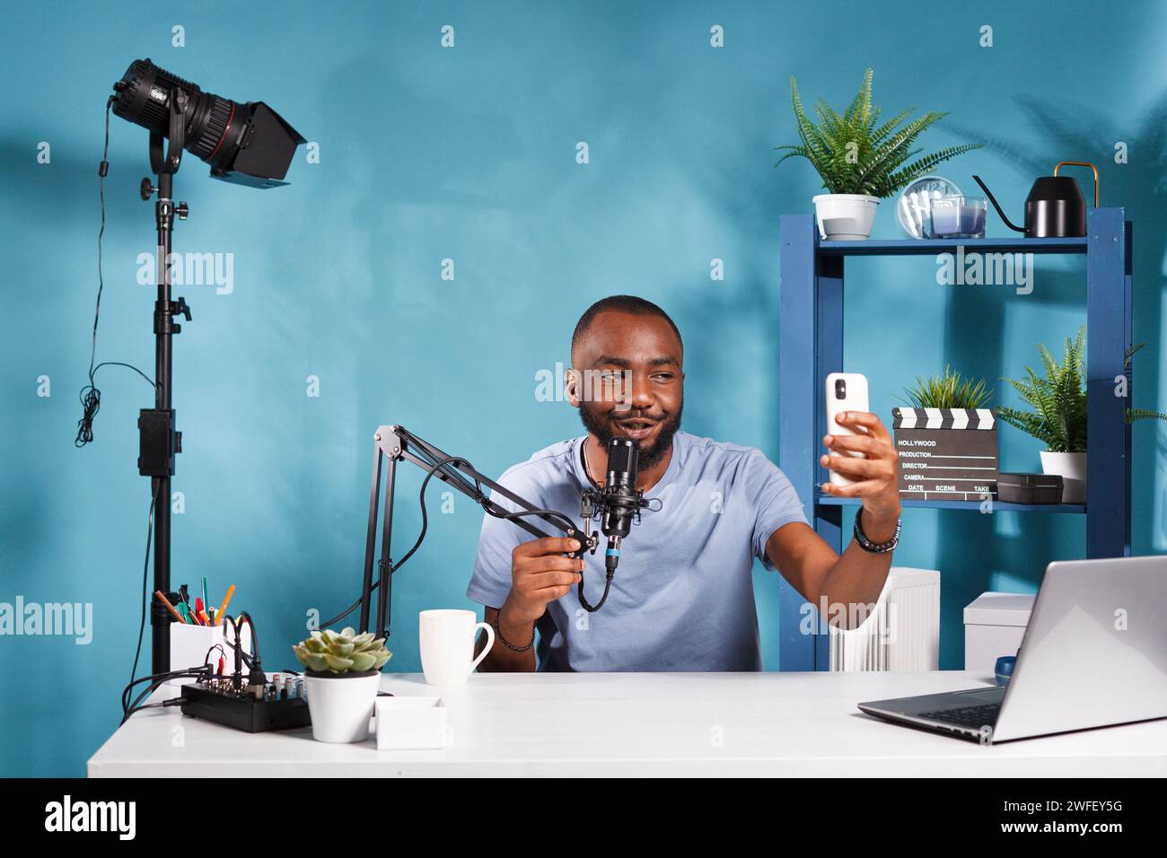 African american vlogger holding smartphone and speaking in microphone ...