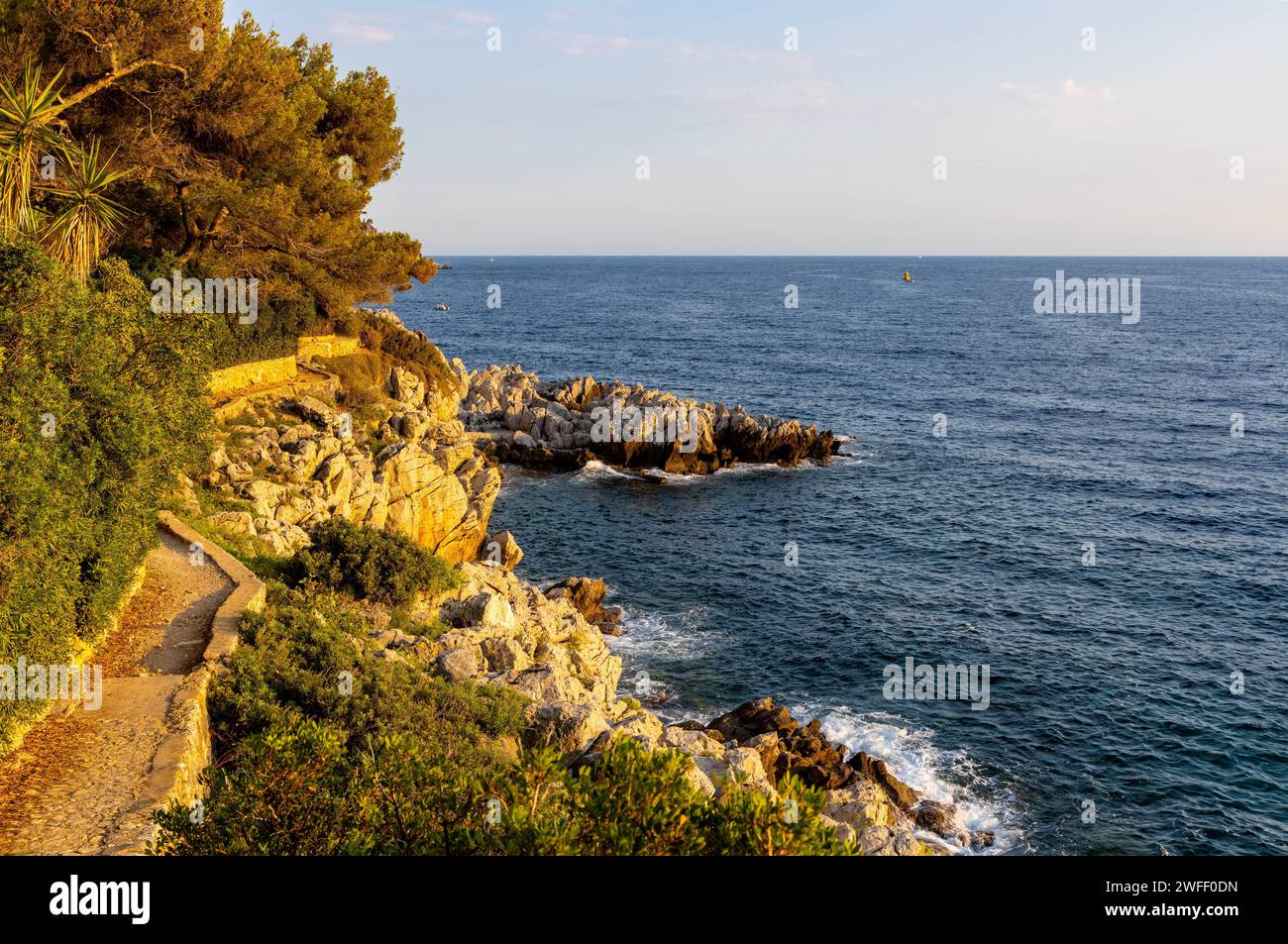 Rocky shoreline landscape of Saint-Jean-Cap-Ferrat resort town with ...