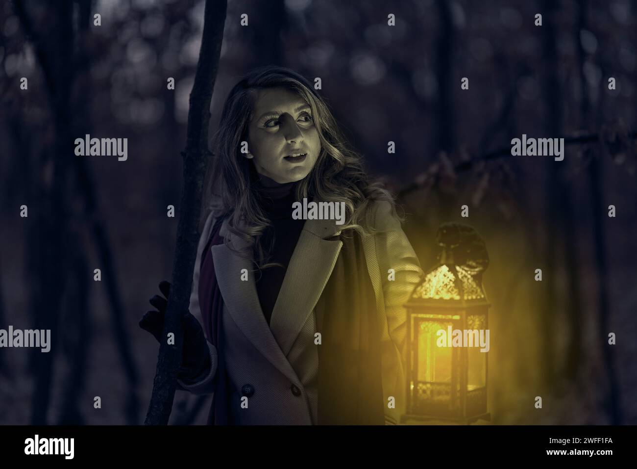 Scared woman at night in the creepy forest with a lantern Stock Photo ...