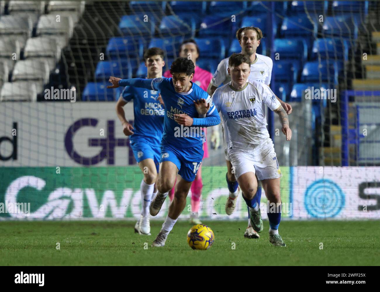 Peterborough, UK. 30th Jan, 2024. Joel Randall (PU) James Tilley (AFCW ...