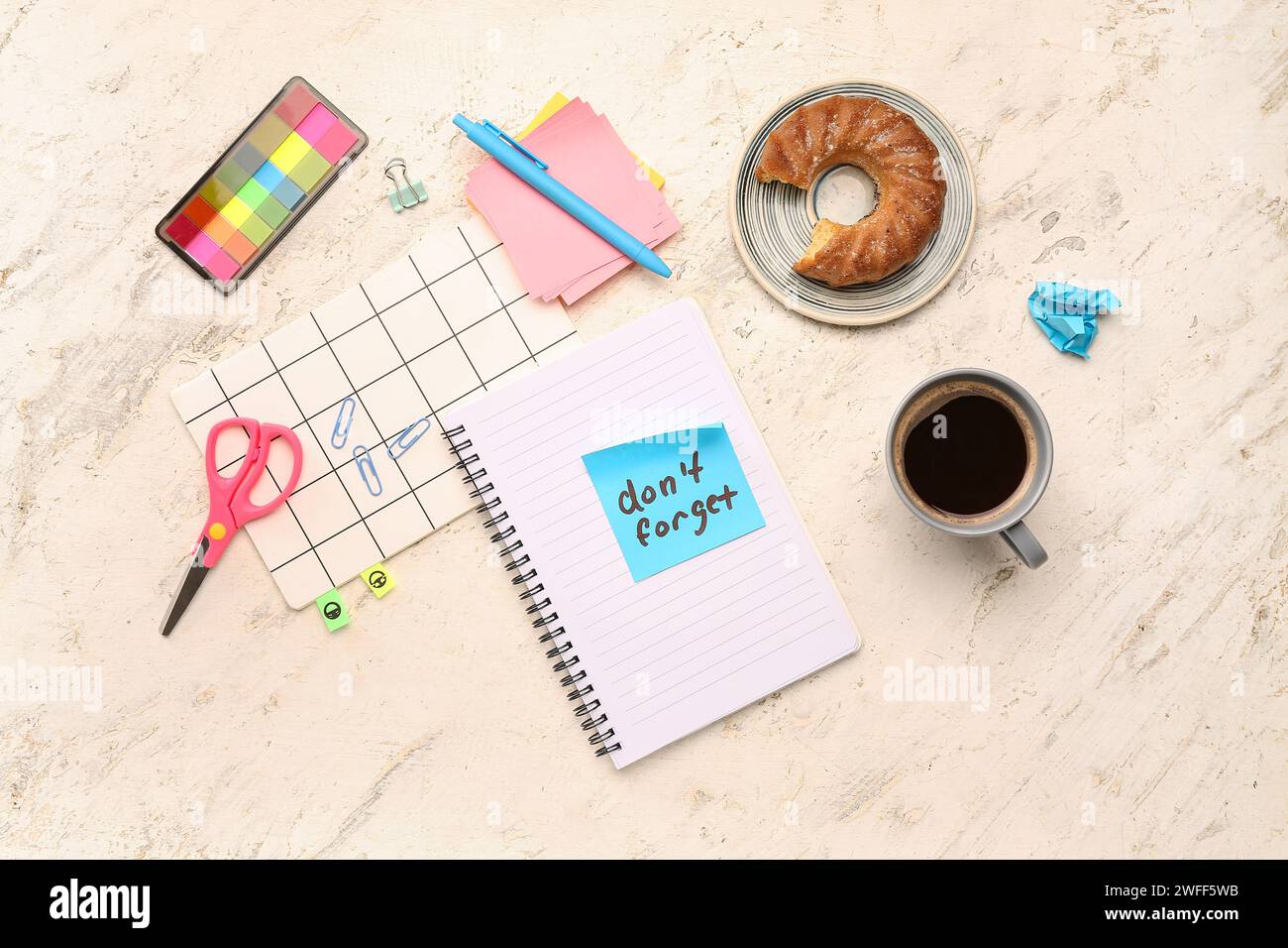 Sticky note with text DON'T FORGET, stationery, coffee cup and ...