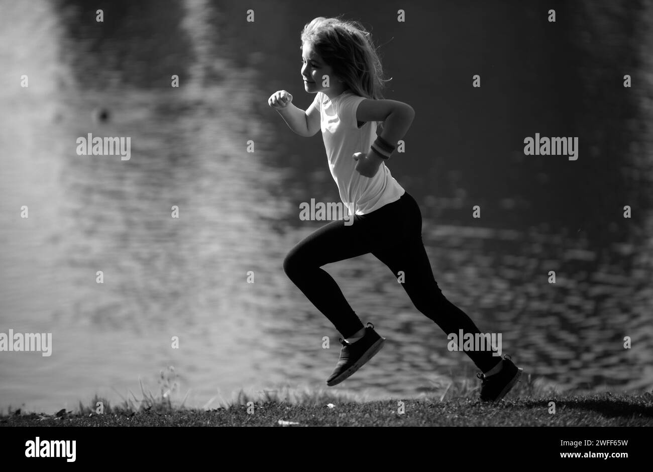 Child boy runners run in park. Sporty young kid jogging and training ...