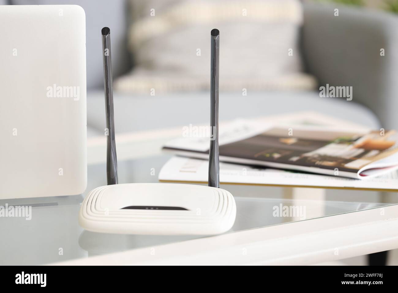 Modern wi-fi router on table in living room, closeup Stock Photo - Alamy