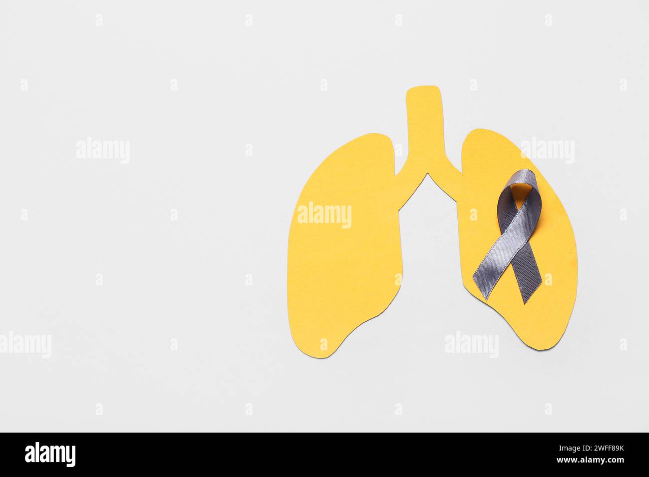 Yellow paper lungs with ribbon on grey background Stock Photo - Alamy