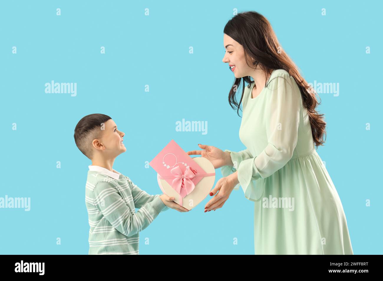 Cute little boy greeting his mother with International Women's Day on ...