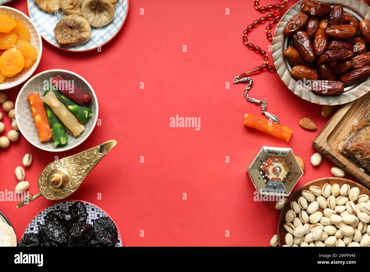 Composition with different Eastern sweets, Aladdin lamp, tasbih and ...