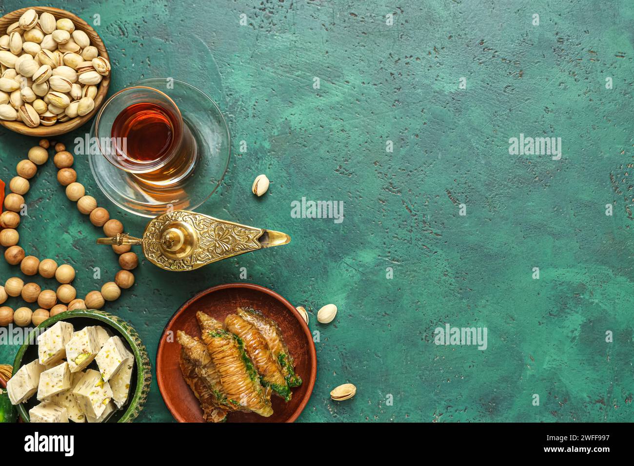 Composition with traditional Eastern sweets, tasbih and Aladdin lamp ...