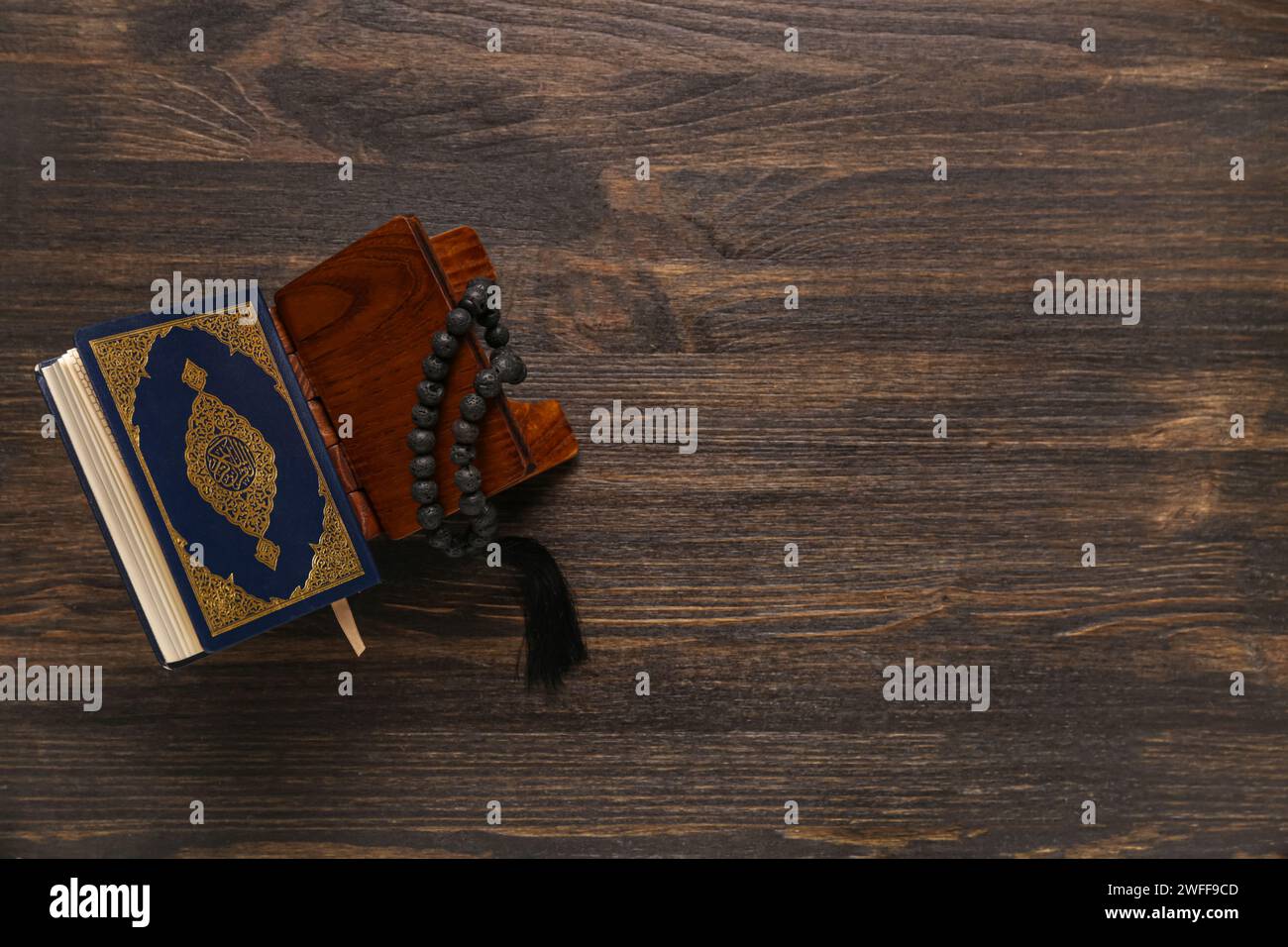 Rehal with Koran and prayer beads for Ramadan on wooden background ...
