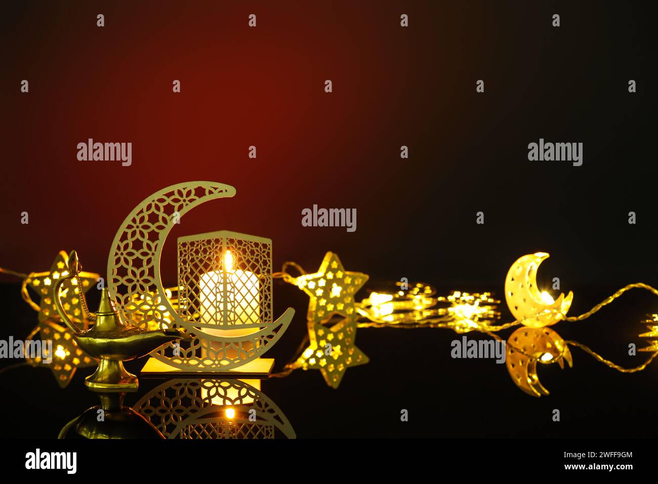 Decorative crescent with burning candle, garland and Aladdin lamp for ...