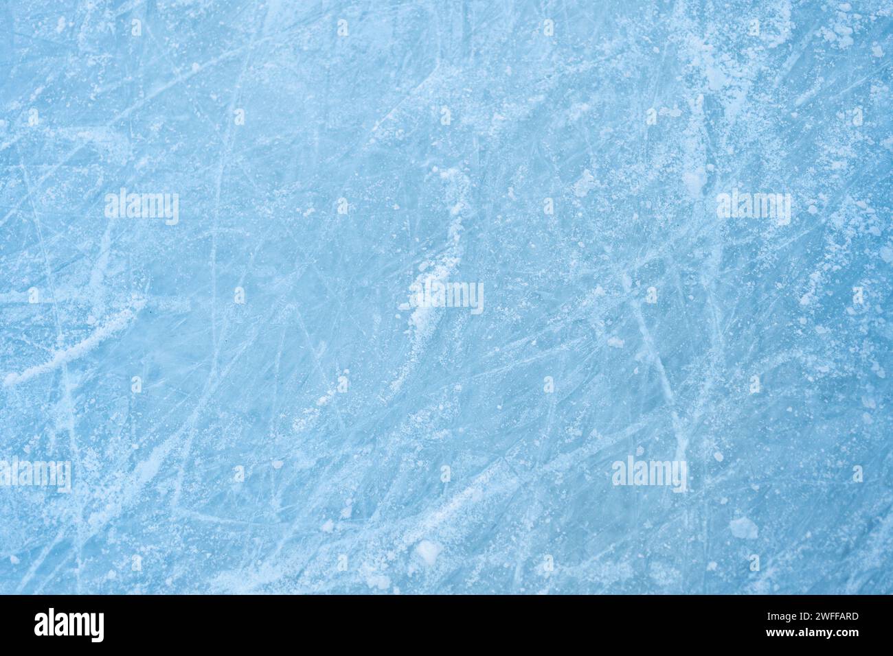 Icy background on rink with visible traces of skating, showcasing the ...