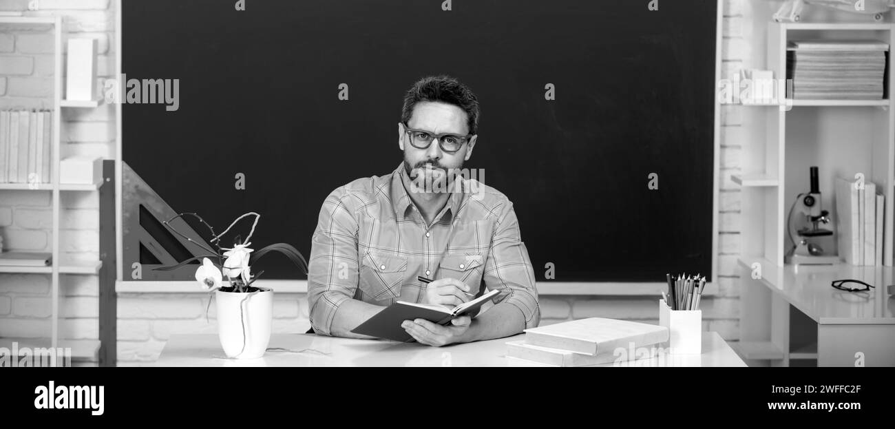 Young modern male teacher waiting for students. Teacher in casual ...