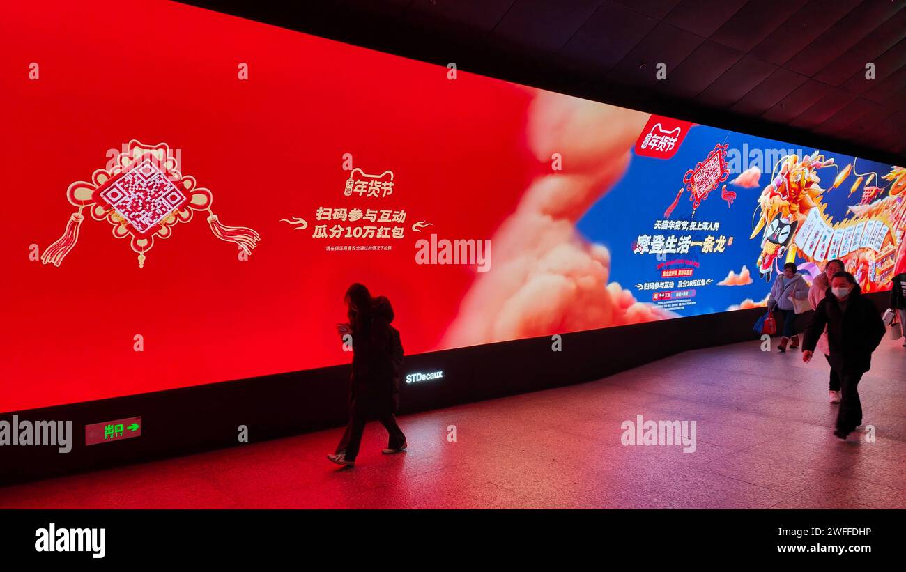 Shanghai, China. 31st Jan, 2024. SHANGHAI, CHINA - JANUARY 29, 2024 - Citizens pass a giant ...