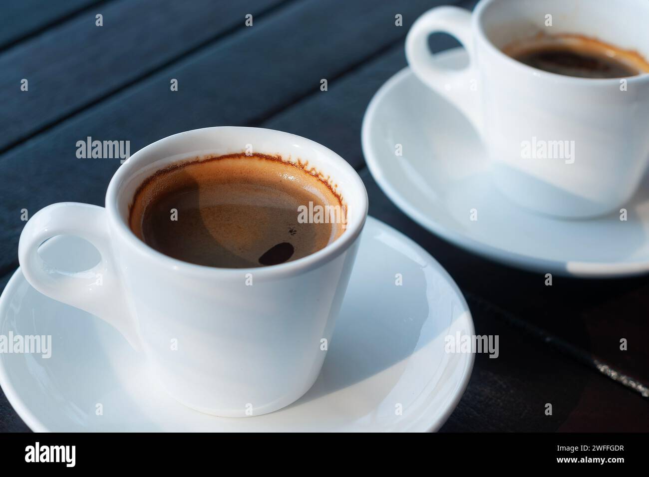 two single and double cups of espresso coffee are placed on the table ...