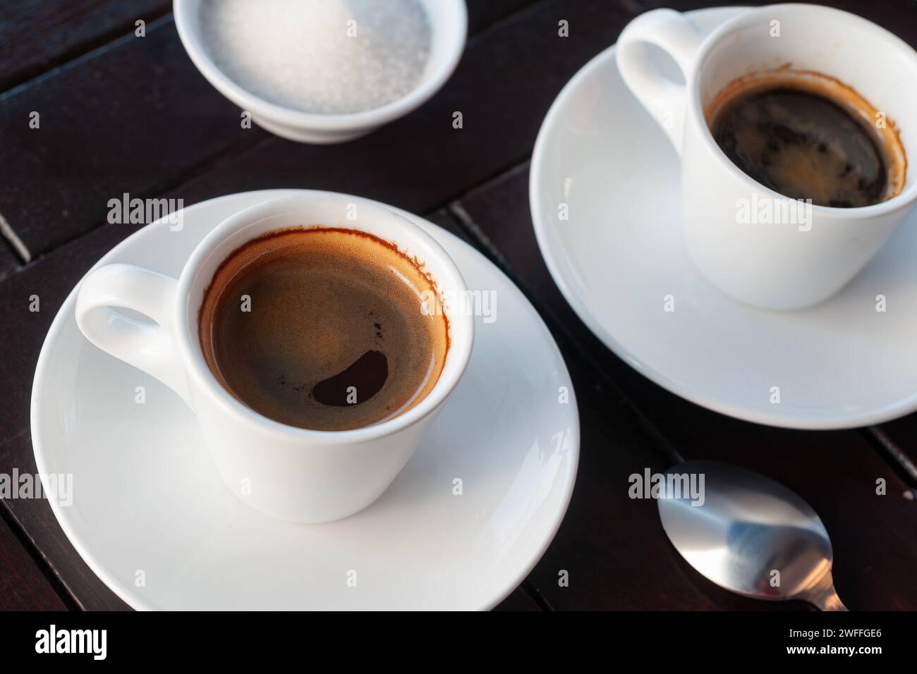 two single and double cups of espresso coffee are placed on the table ...