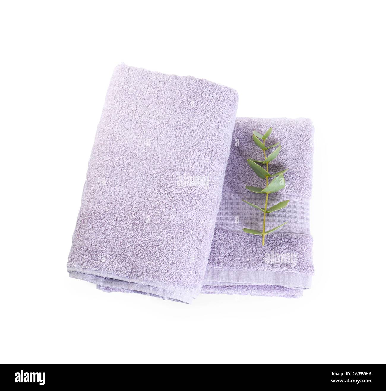 Violet terry towels and eucalyptus branch isolated on white, top view ...