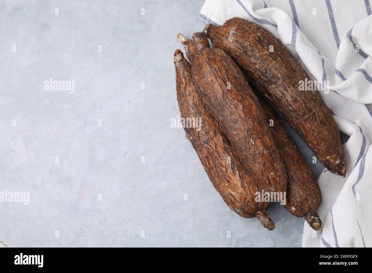 Fresh cassava roots on grey table, top view. Space for text Stock Photo ...