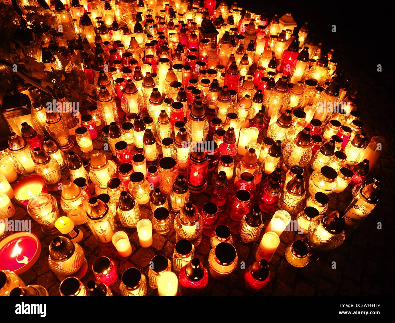 a large group of candles with red and white candles (All Saint's Day in ...