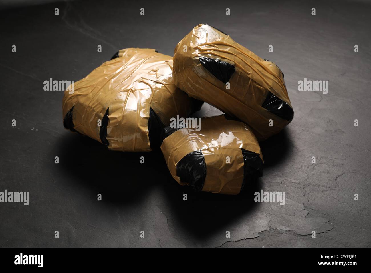 Packages with narcotics on black table. Drug addiction Stock Photo - Alamy