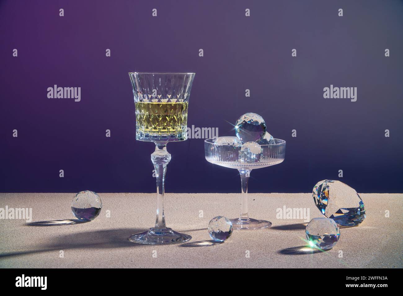 A glass of champagne wine or yellow beverage displayed with a glass ...