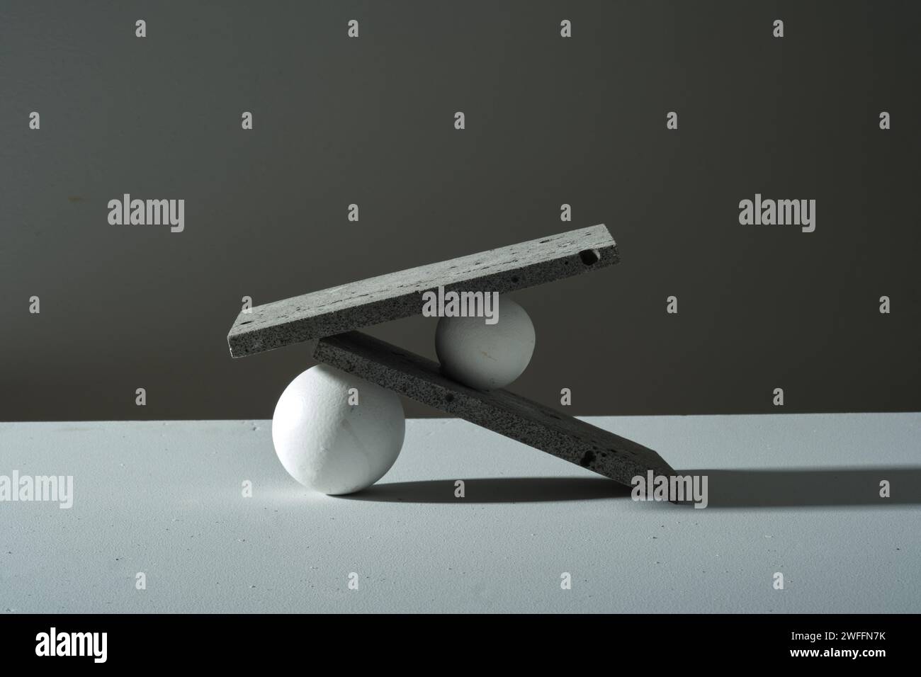 Against the dark gray background, a stack of rectangle stone podium and ...