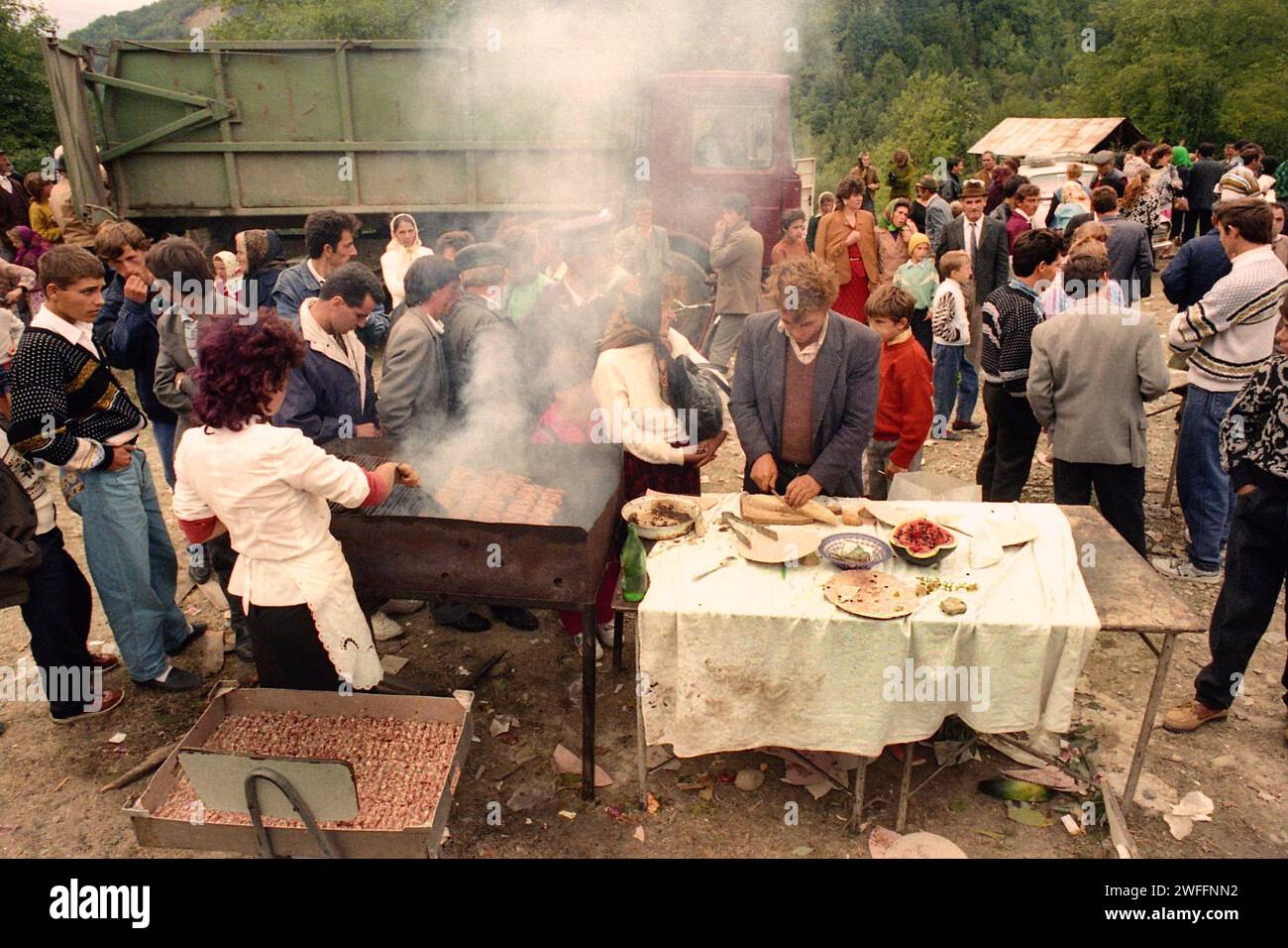 Country fair in Vrancea County, Romania, 1990. People standing in line ...
