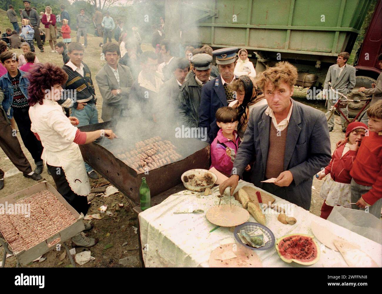 Country fair in Vrancea County, Romania, 1990. People standing in line ...