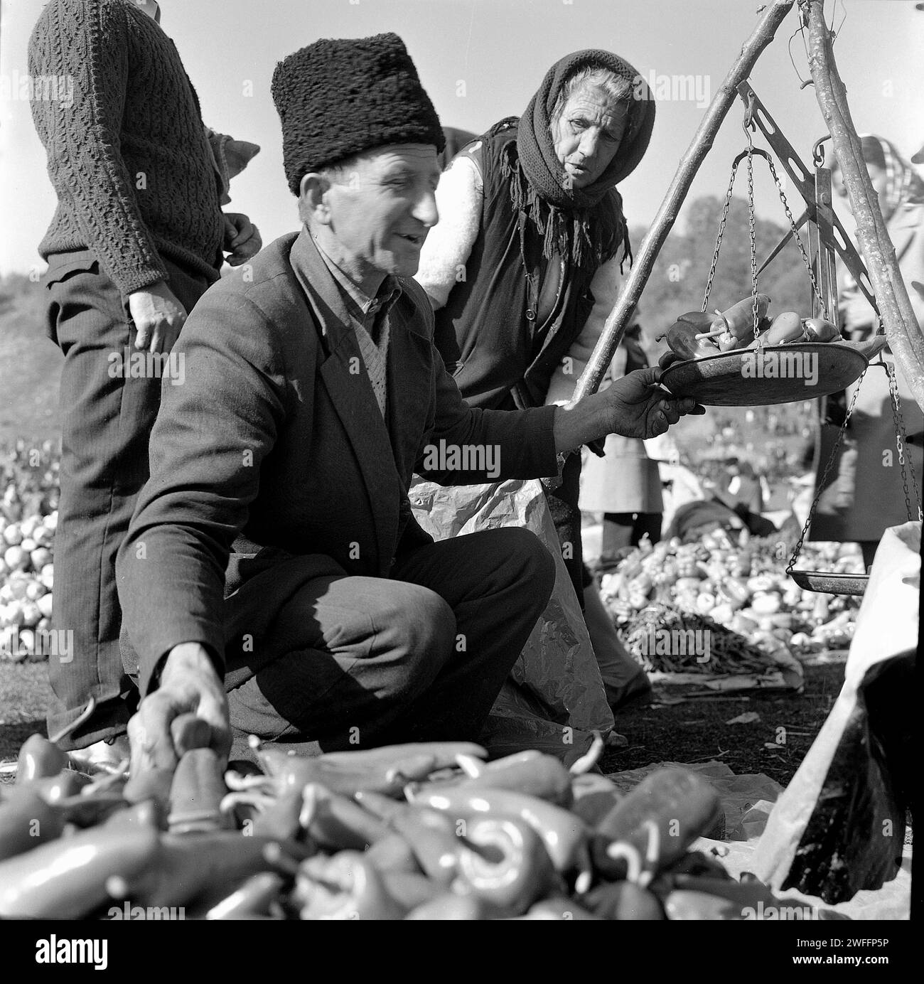 Vrancea County, Romania, approx. 1979. Peasant selling vegetables at a ...