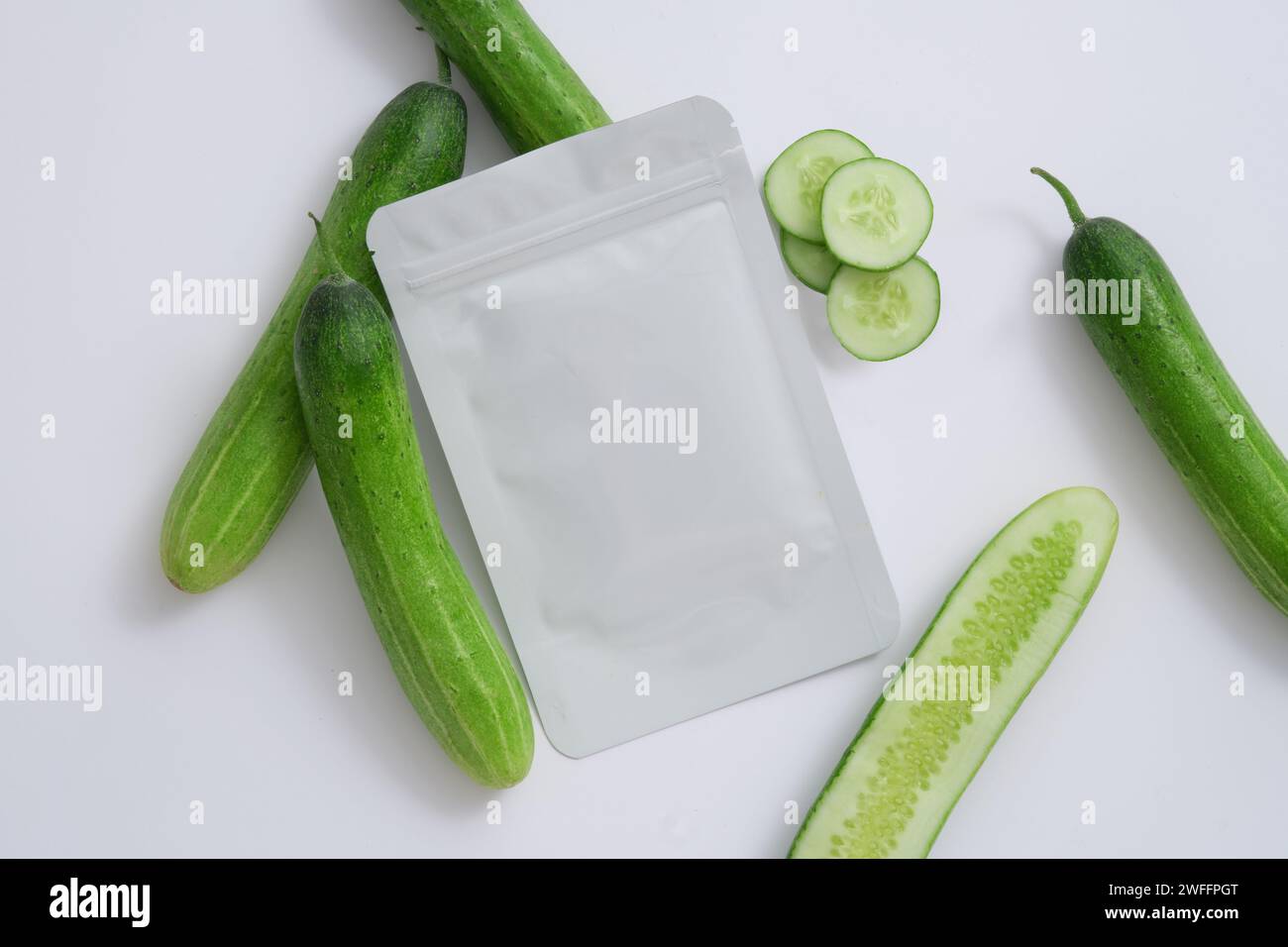 Facial beauty sheet mask without label arranged with some Cucumbers ...