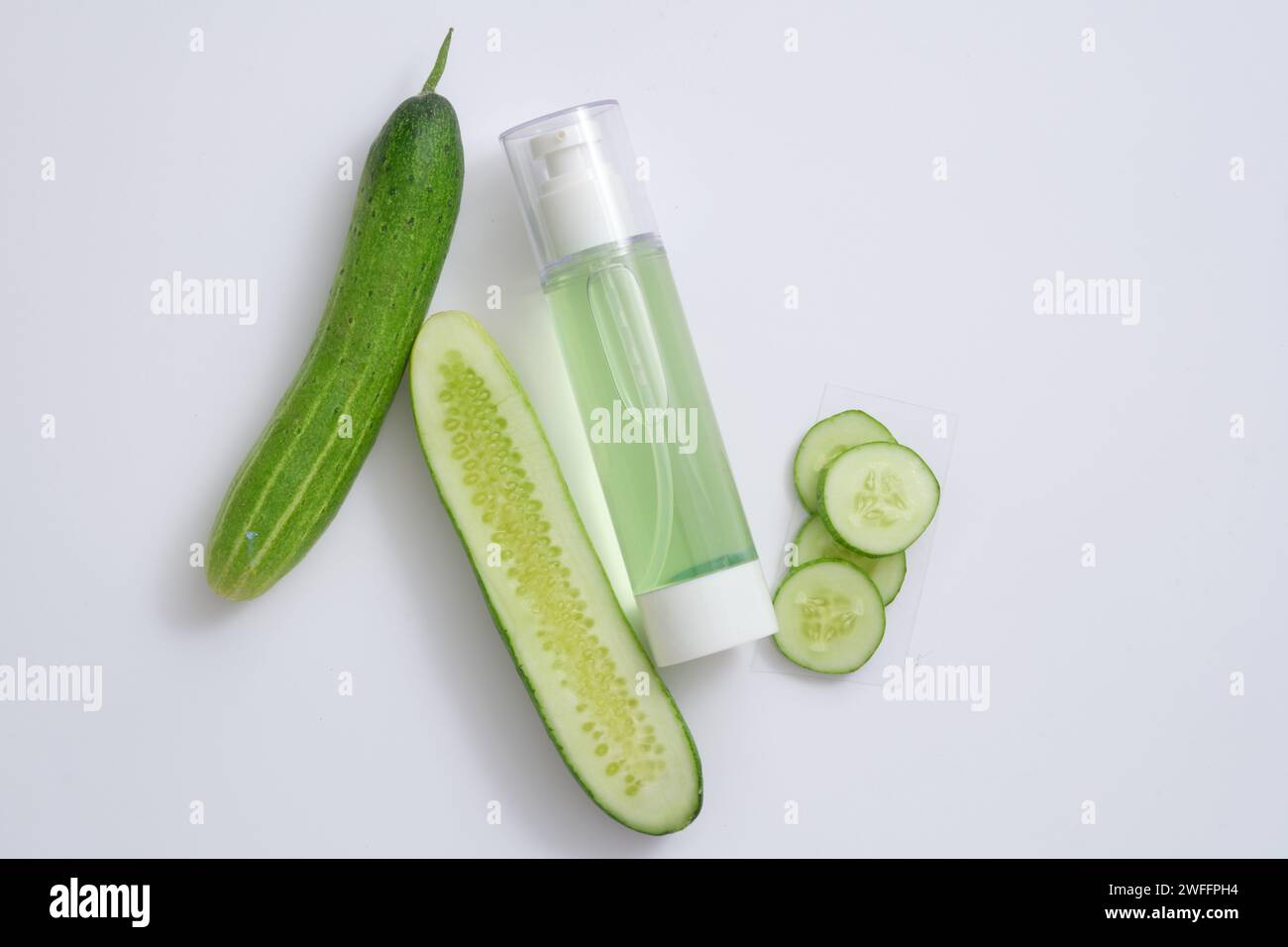 Pump bottle filled with liquid extracted from Cucumber decorated with ...