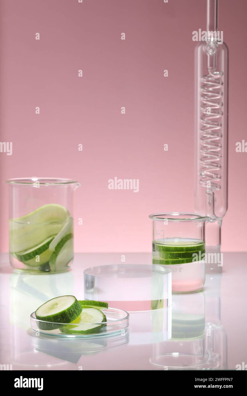 Laboratory scene with beakers, glass petri dish of Cucumber slices and ...