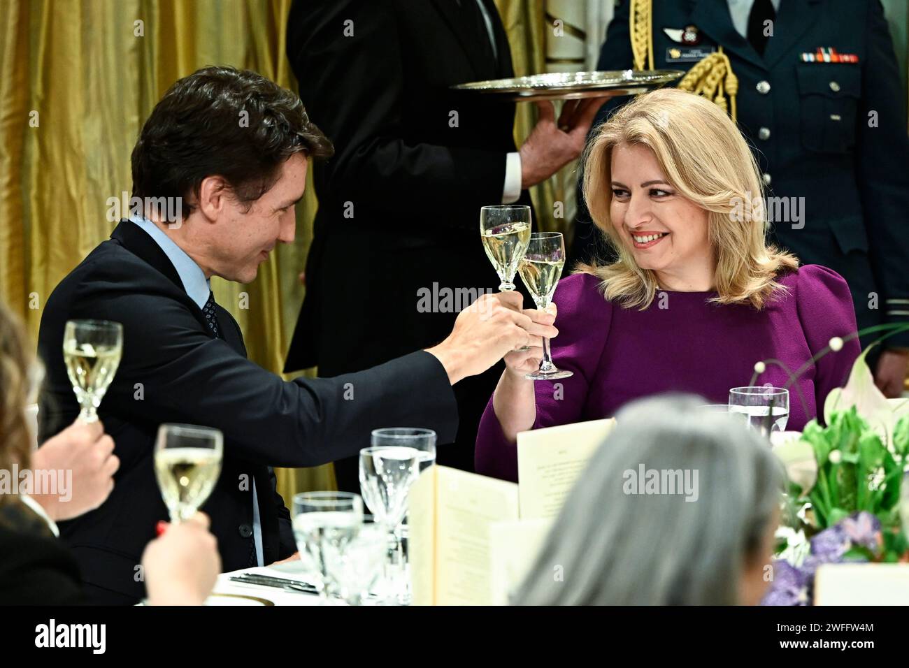 Prime Minister of Canada Justin Trudeau, left, clinks glasses with ...