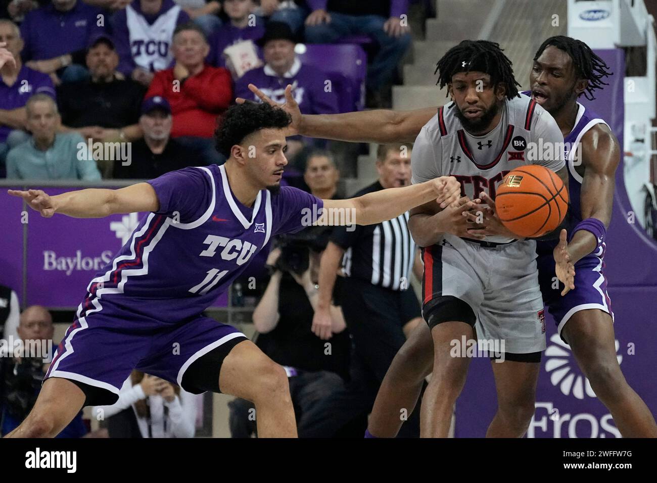 TCU guard Trevian Tennyson (11) and Ernest Udeh Jr., right, rear ...