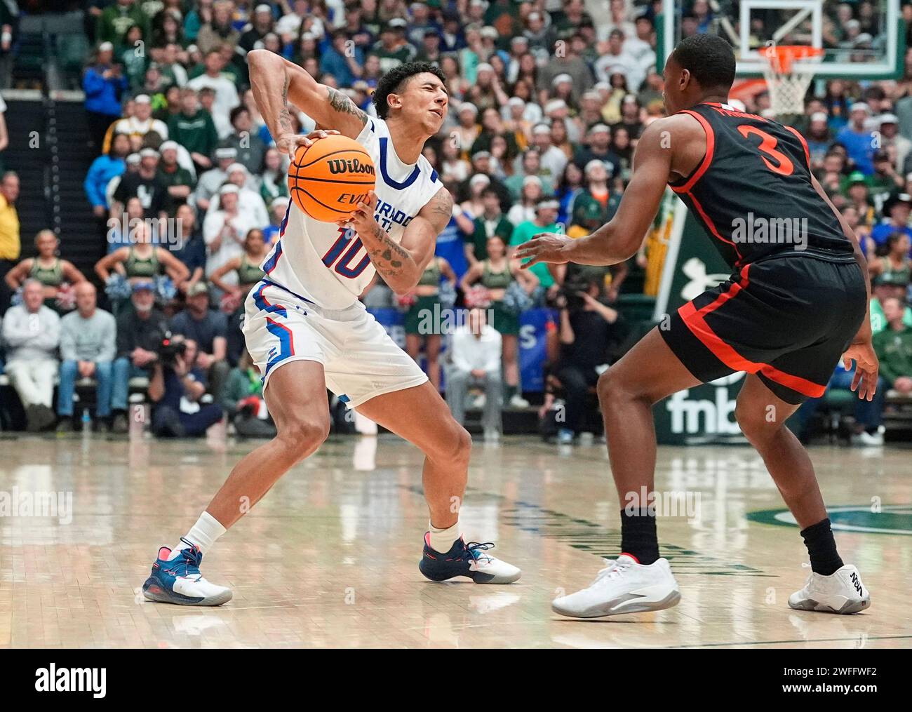 Colorado State guard Nique Clifford, left, looks to pass the ball as ...