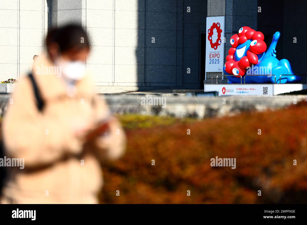 A Pedestrian walks past a statue of Myaku-Myaku, the mascot for the ...