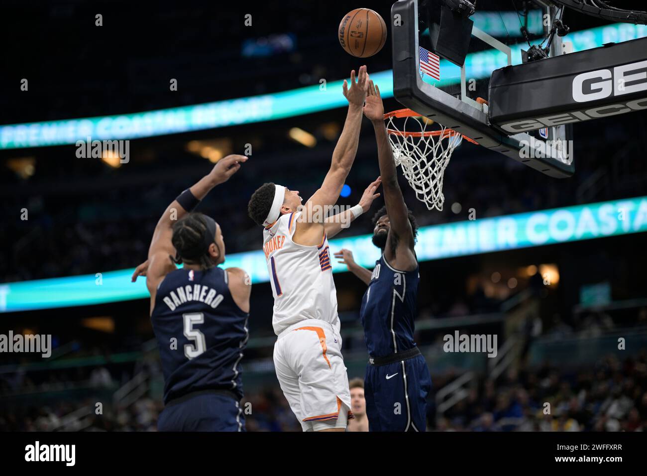 Phoenix Suns guard Devin Booker (1) shoots between Orlando Magic ...
