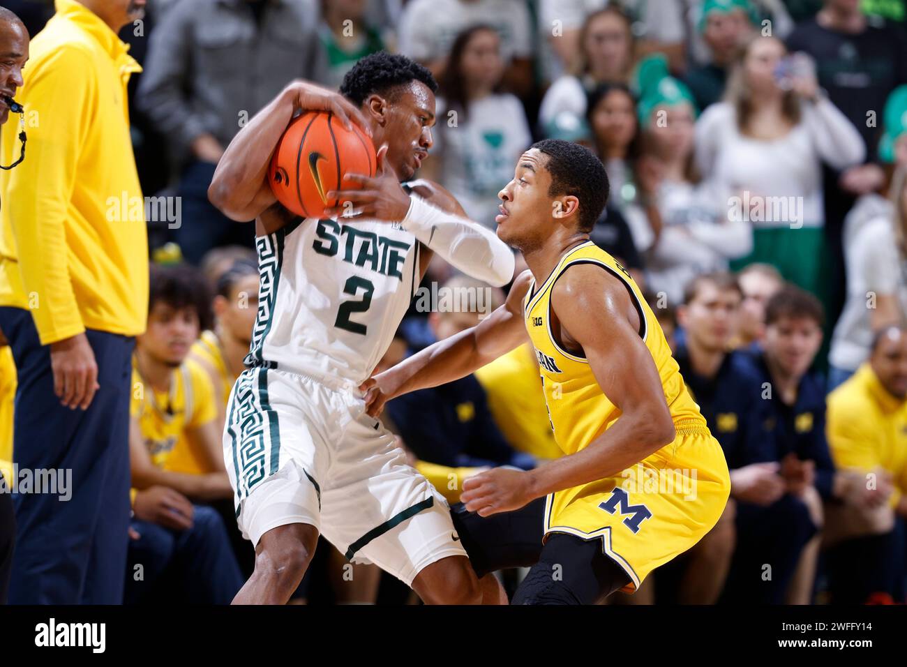 Michigan State guard Tyson Walker (2), left, is pressured by Michigan guard Nimari Burnett ...
