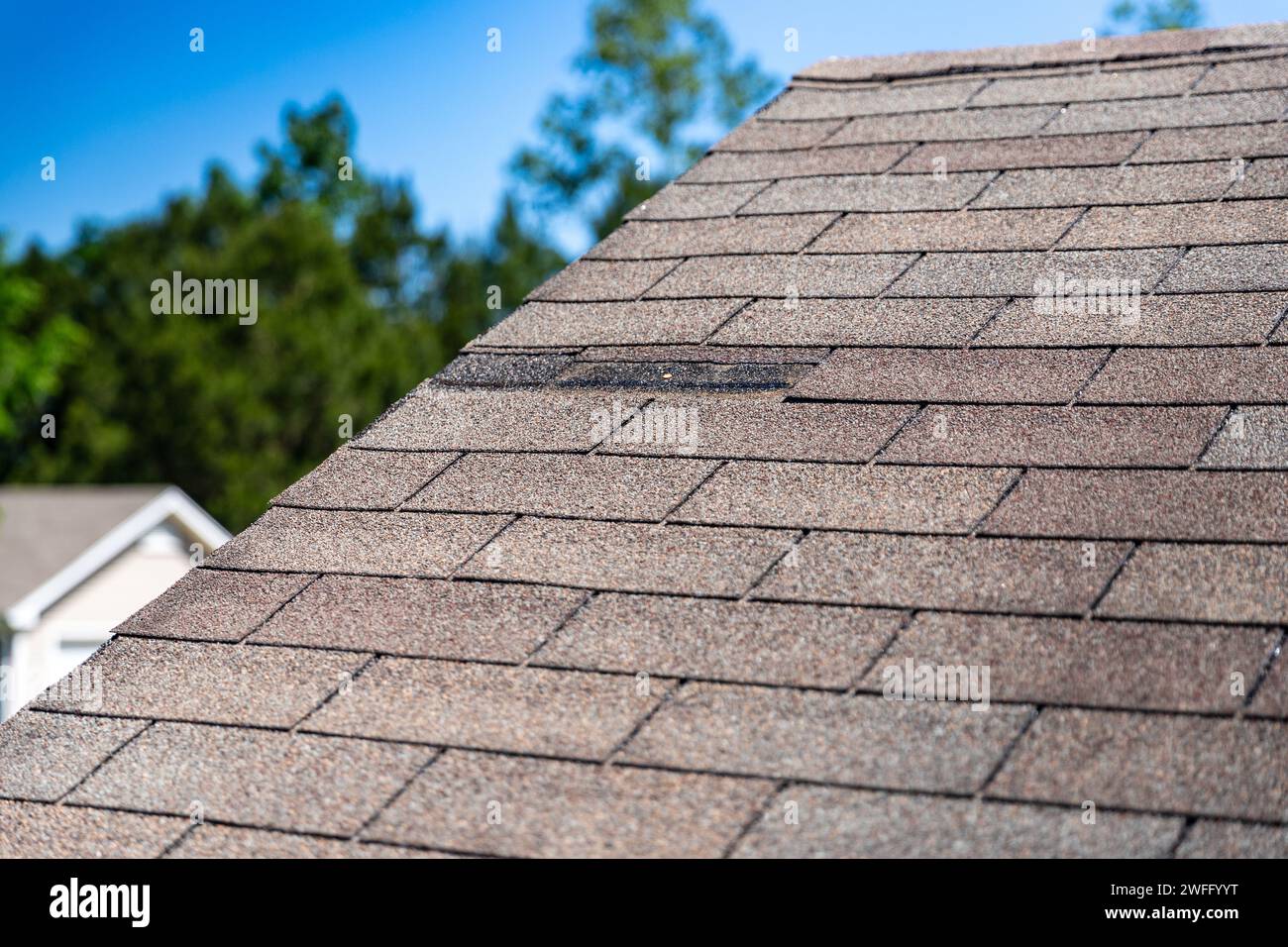 Missing shingles on roof due to storm damage Stock Photo - Alamy